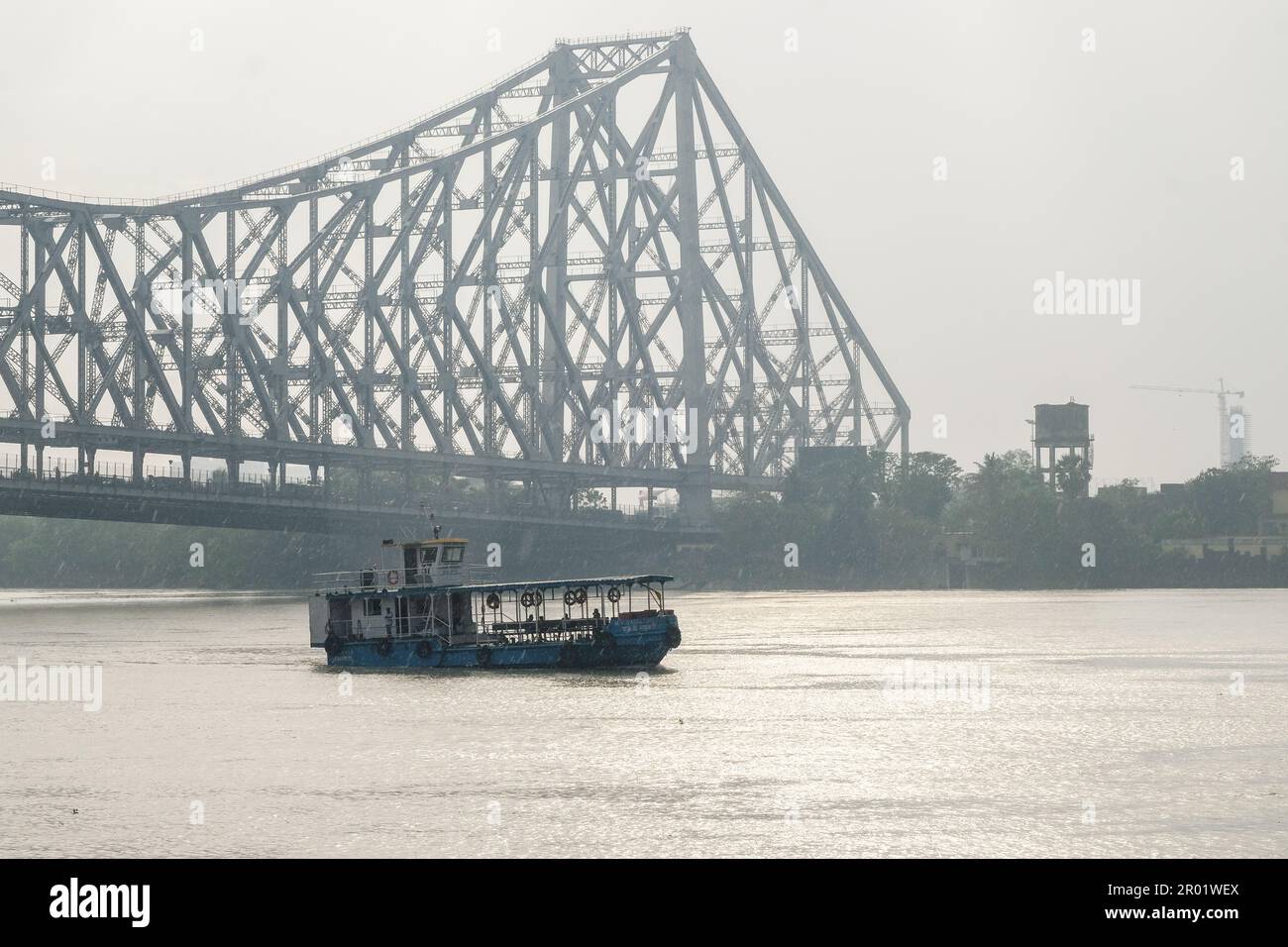 A motorized ferry is sailing at the holy river Ganga with the ...