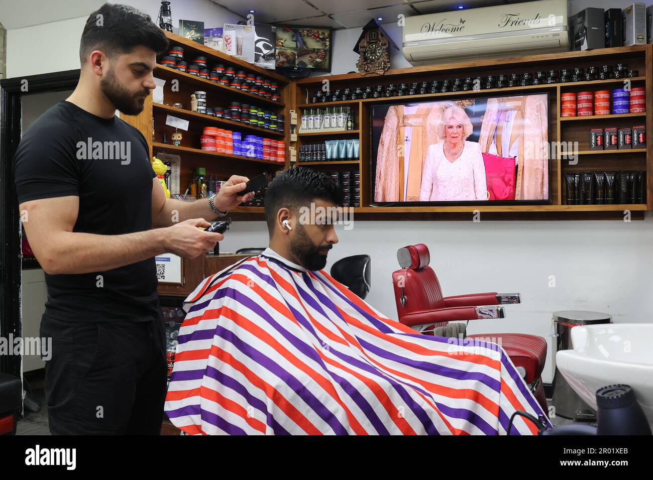 London, UK. May 6, 2023. A TV screen shows the Coronation of King ...