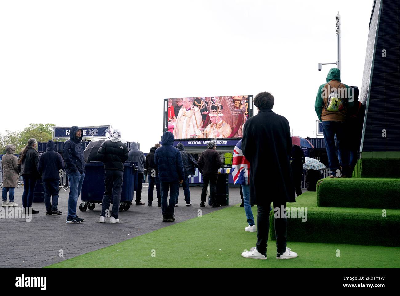 People watch the coronation of King Charles III on a big screen in Park ...