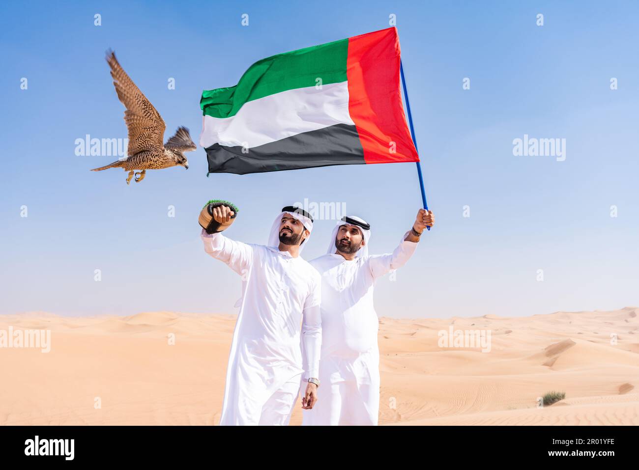 Two middle-eastern men wearing traditional emirati arab kandura bonding ...