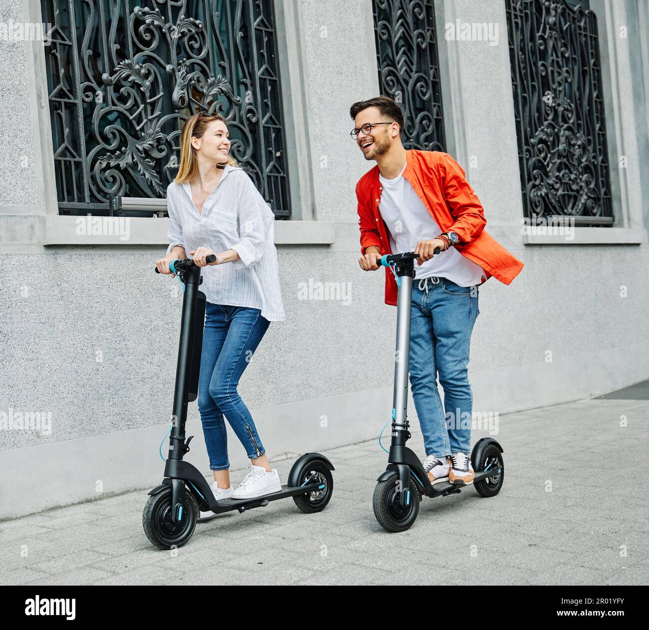 couple young electric scooter city transport riding technology ...