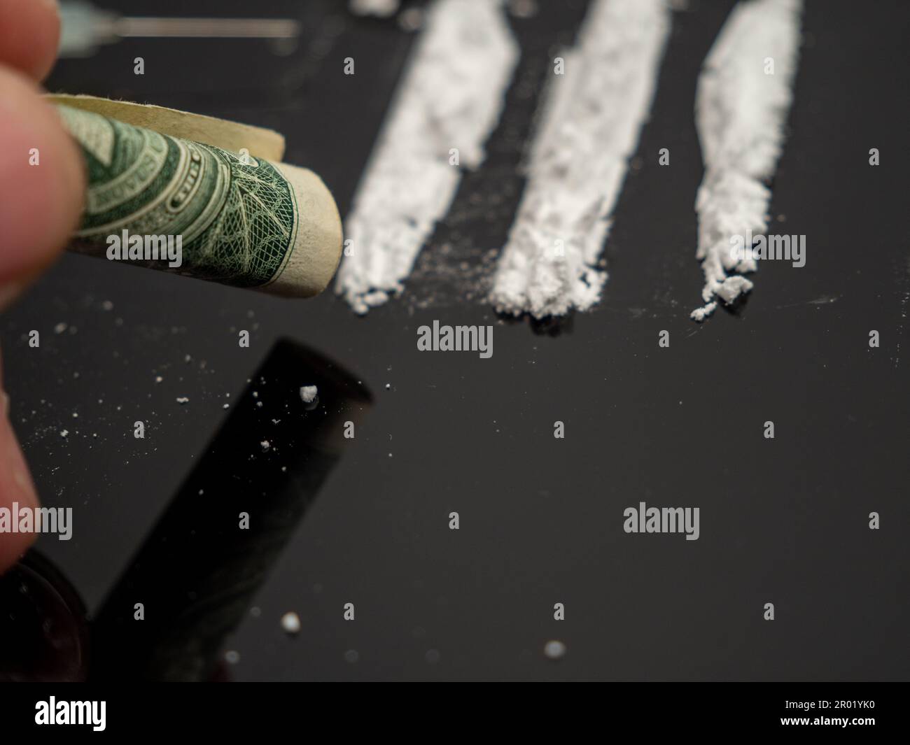 Syringe for injection and cocaine powder, on a black background. Drugs ...