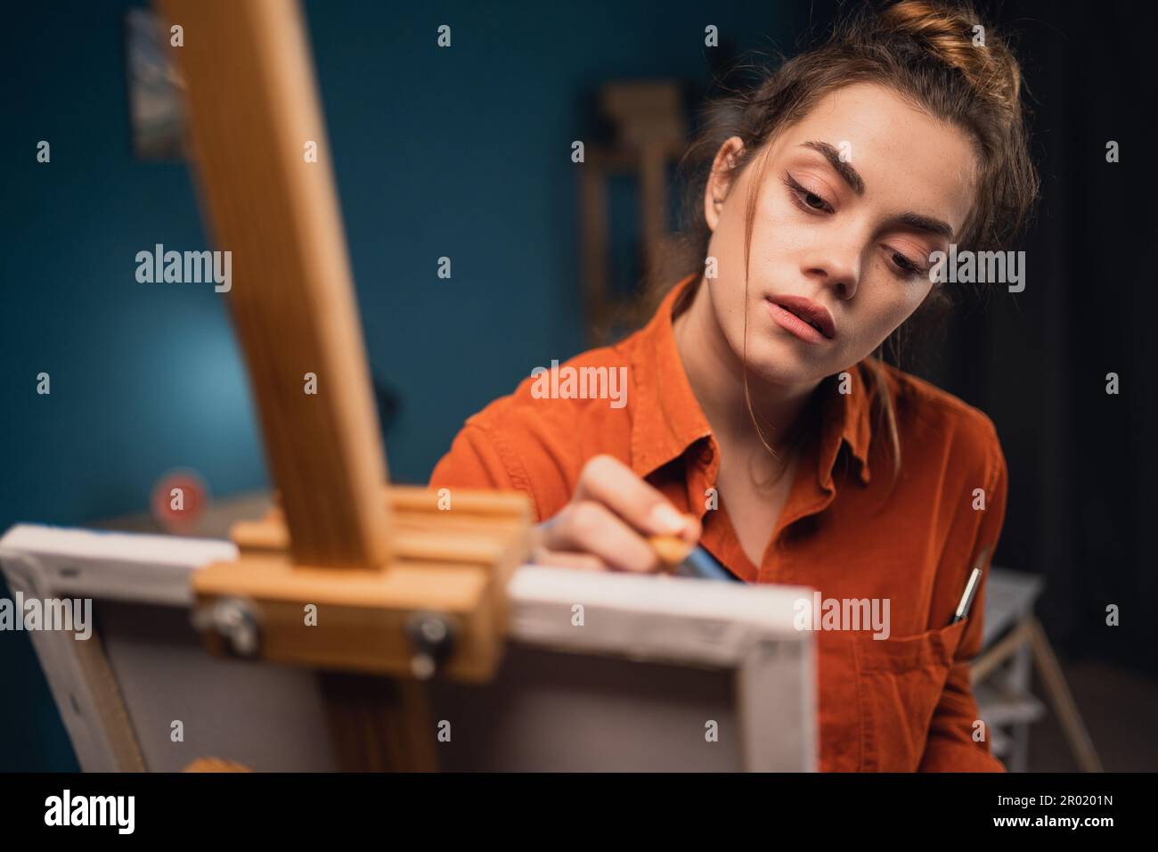 Art school class. Portrait of female painter creating abstract artwork ...