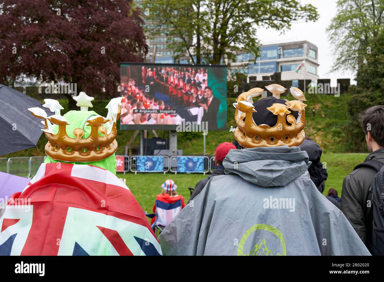 Crowd watching the coronation of Charles III on a big screen in the ...