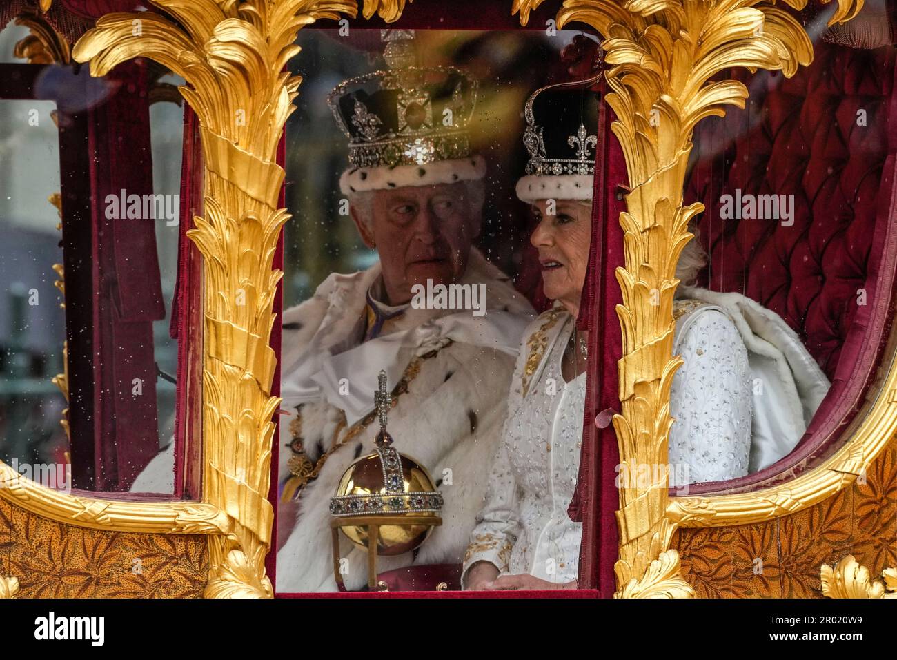 Britain's King Charles III, left, and Queen Camilla depart Westminster ...