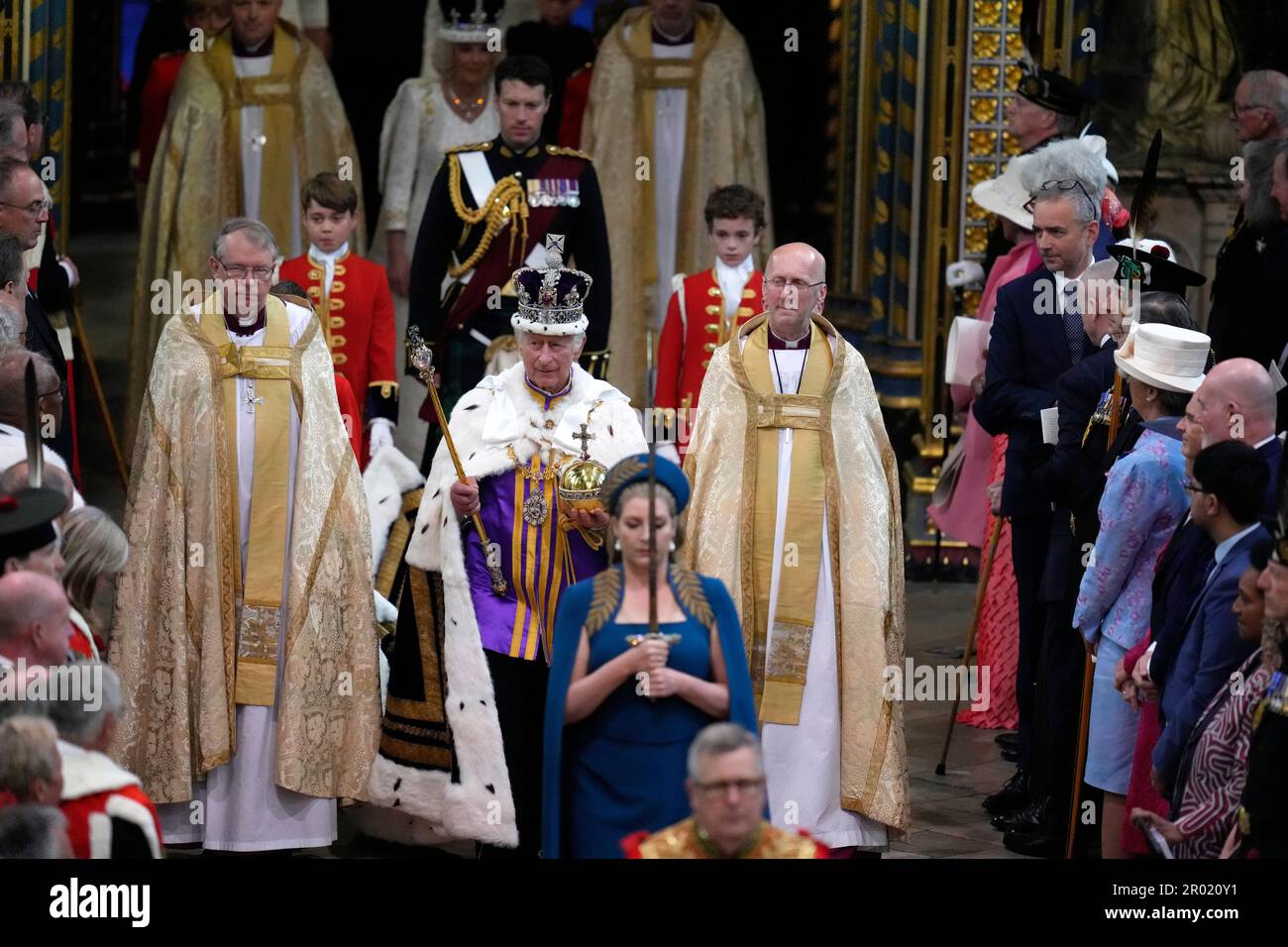 Britain's King Charles III, center, walks in the Coronation Procession ...