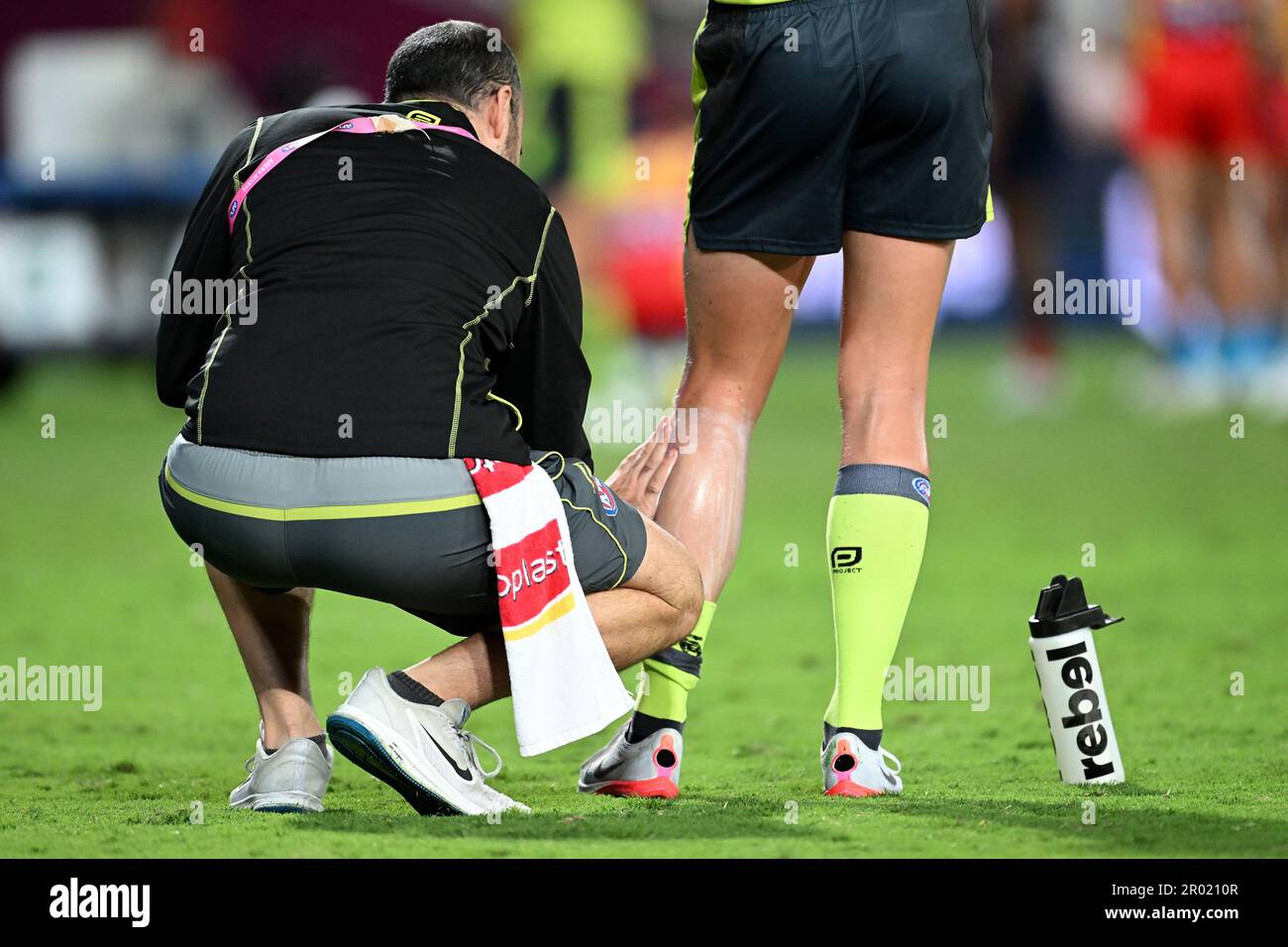 An umpire has treatment applied to his leg during the AFL Round 8 match ...