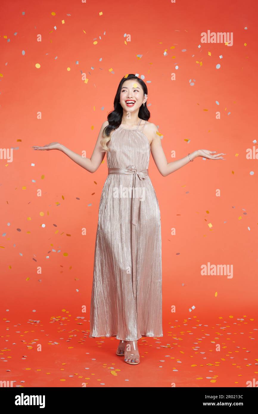 happy young woman or teen girl in fancy dress with sequins and confetti ...