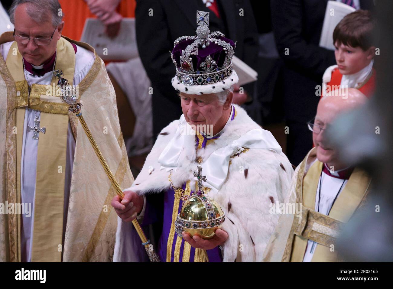 Britain's King Charles III wears the Imperial State Crown and holds the ...