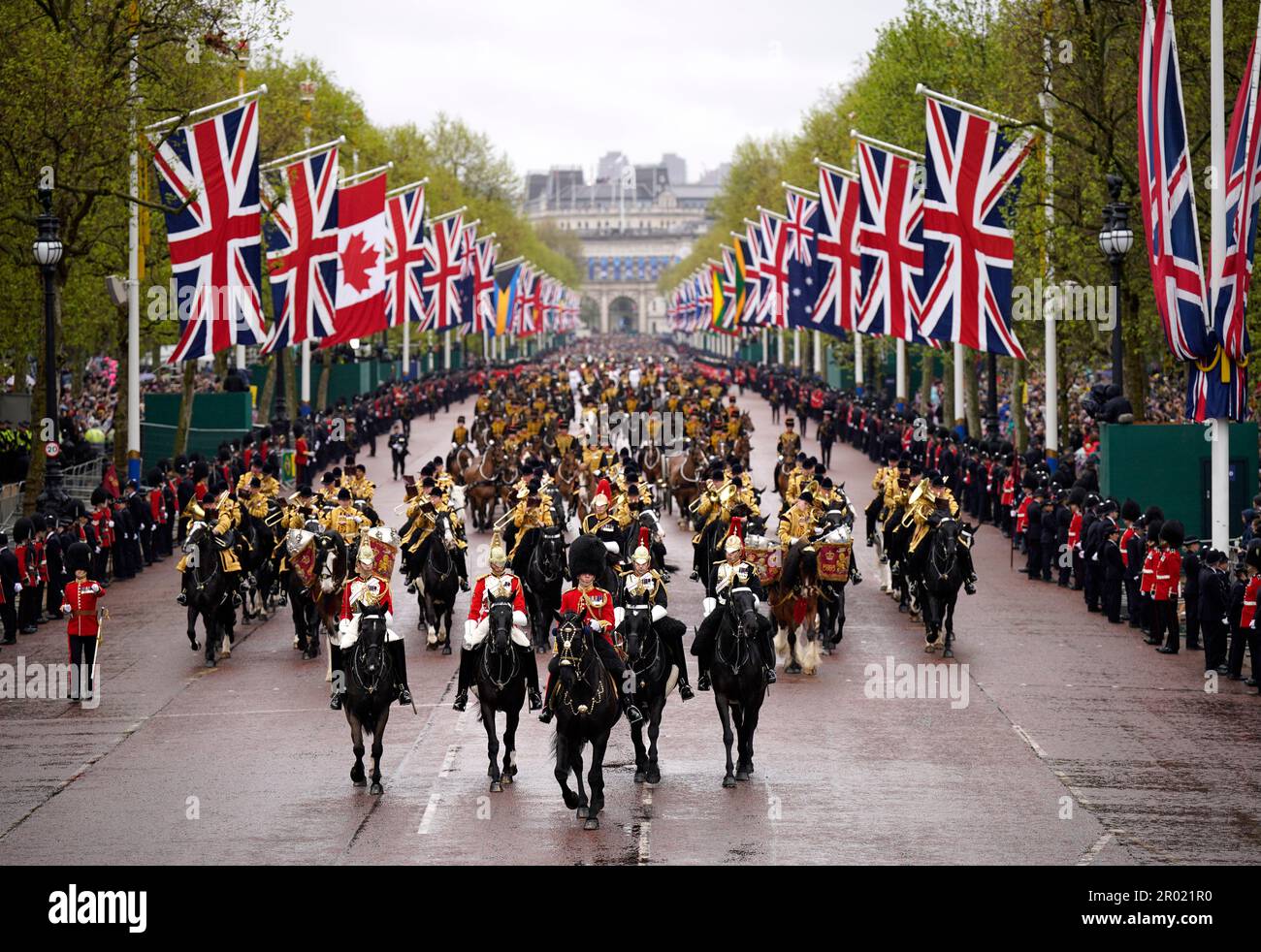 The Coronation Procession passes along The Mall to Buckingham Palace ...