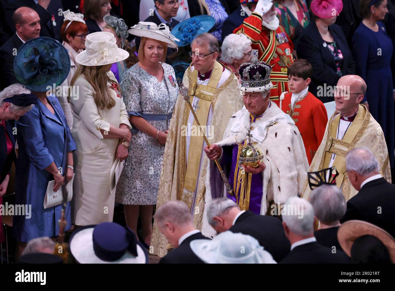 Britain's King Charles III wears the Imperial State Crown and holds the ...