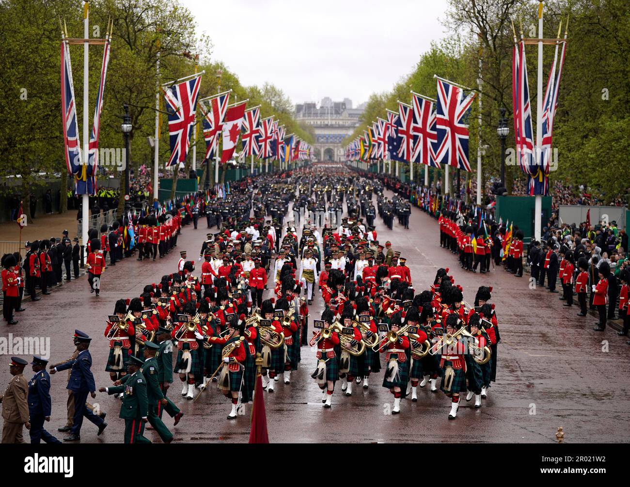 The Coronation Procession passes along The Mall to Buckingham Palace ...