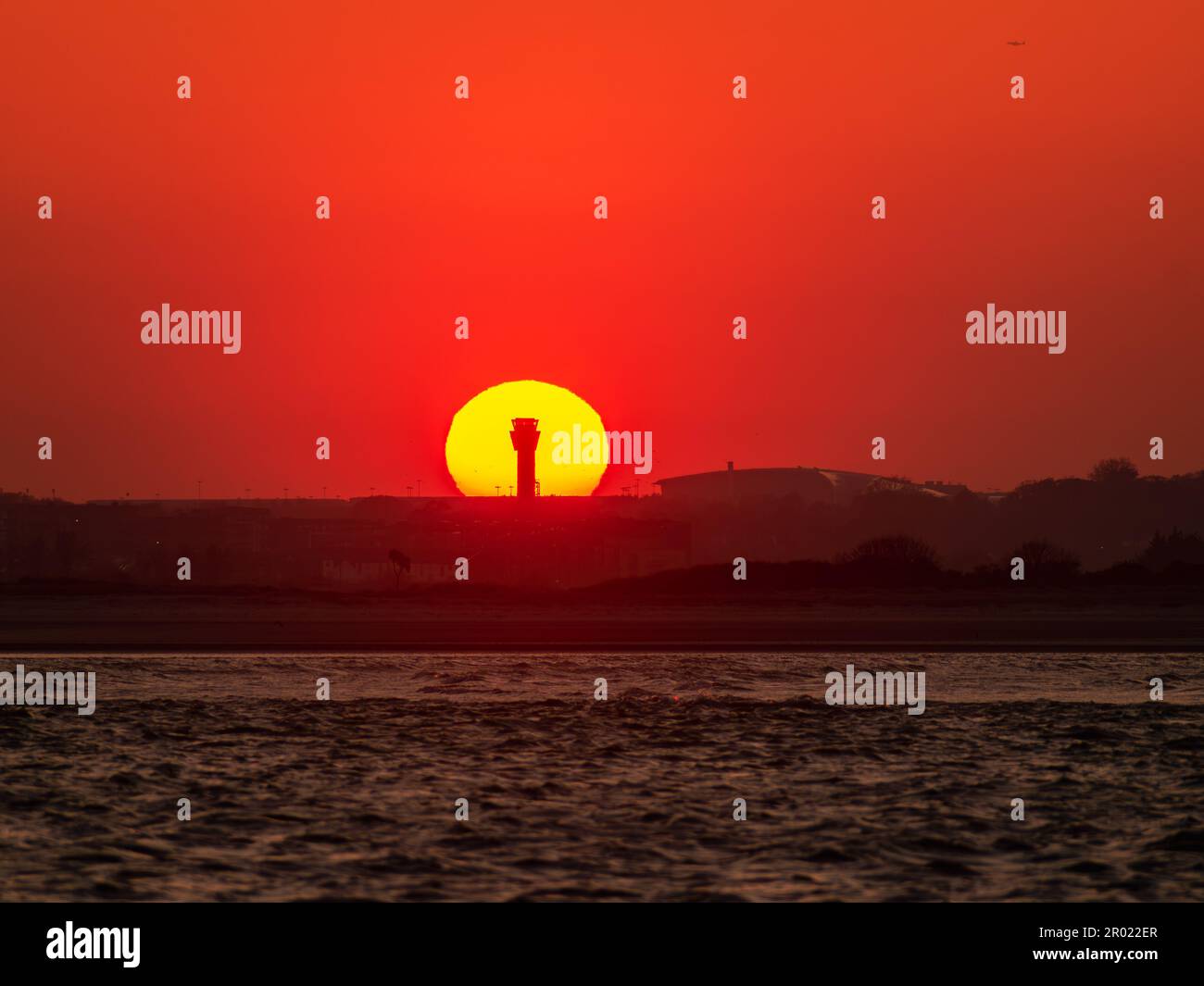Sunset behind the Dublin Airport control tower from Burrow Beach with ...