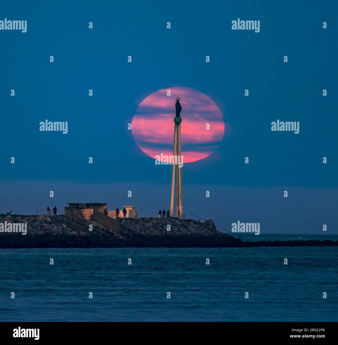 The full Flower Moon rising behind Our Lady Star of the Sea statue at ...