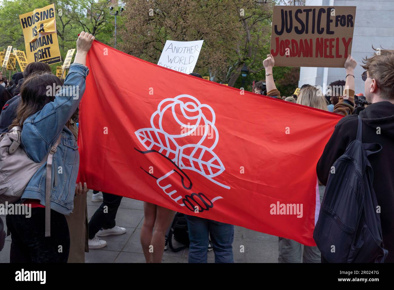 A couple holds a flag at a "Justice for Jordan Neely" rally in ...