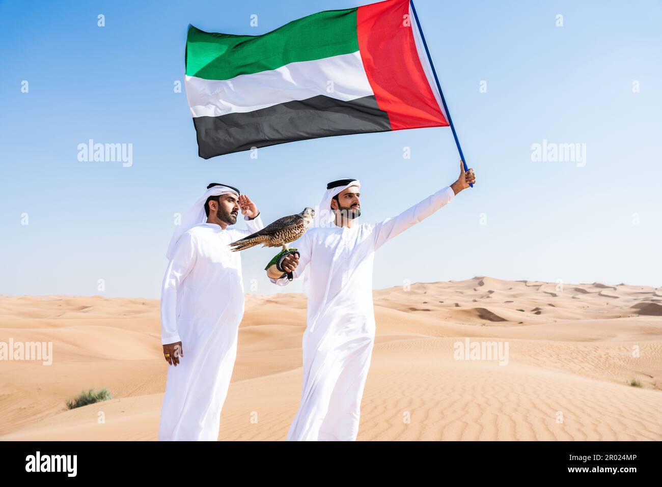 Two middle-eastern men wearing traditional emirati arab kandura bonding ...
