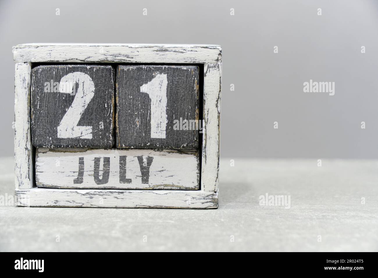 Calendar for July 21, made of wooden cubes, on gray background.With an ...