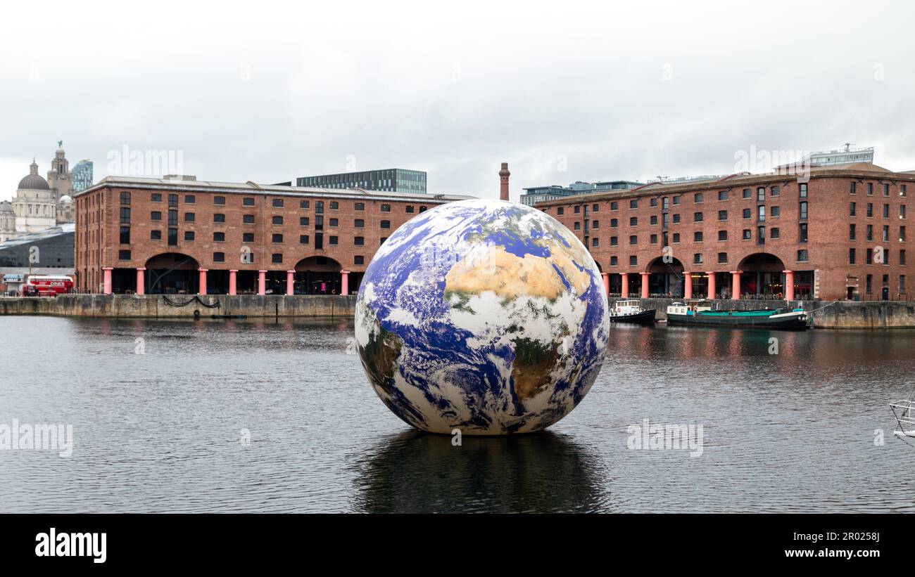 Floating Earth Artwork and visitors at Liverpool's Albert Dock Stock ...