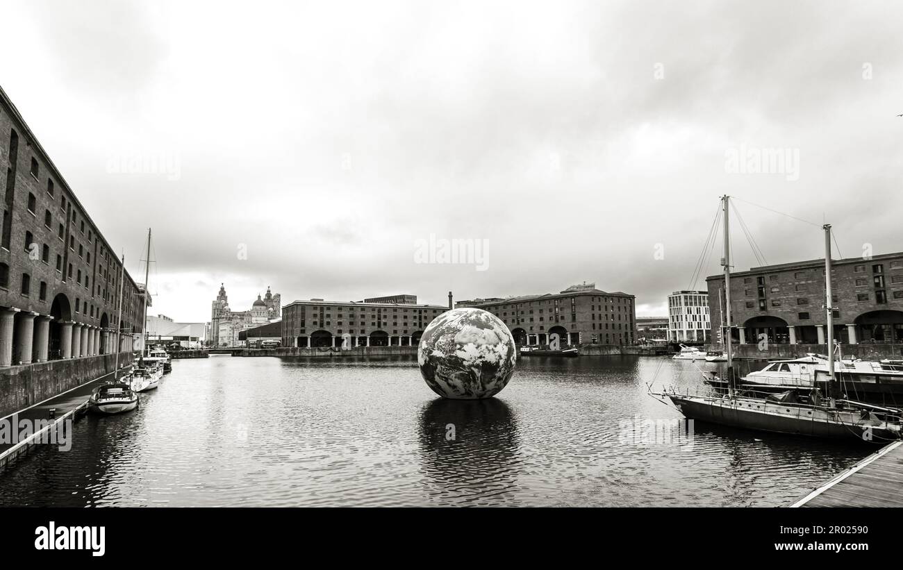 Floating Earth Artwork and visitors at Liverpool's Albert Dock Stock ...
