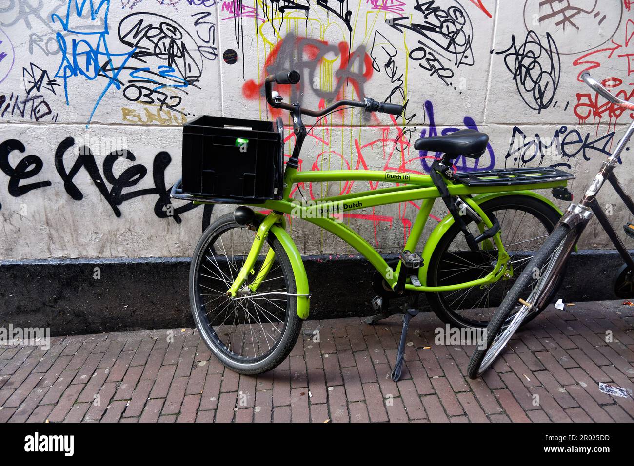 Typical Amsterdam street scene of street art graffiti and parked ...