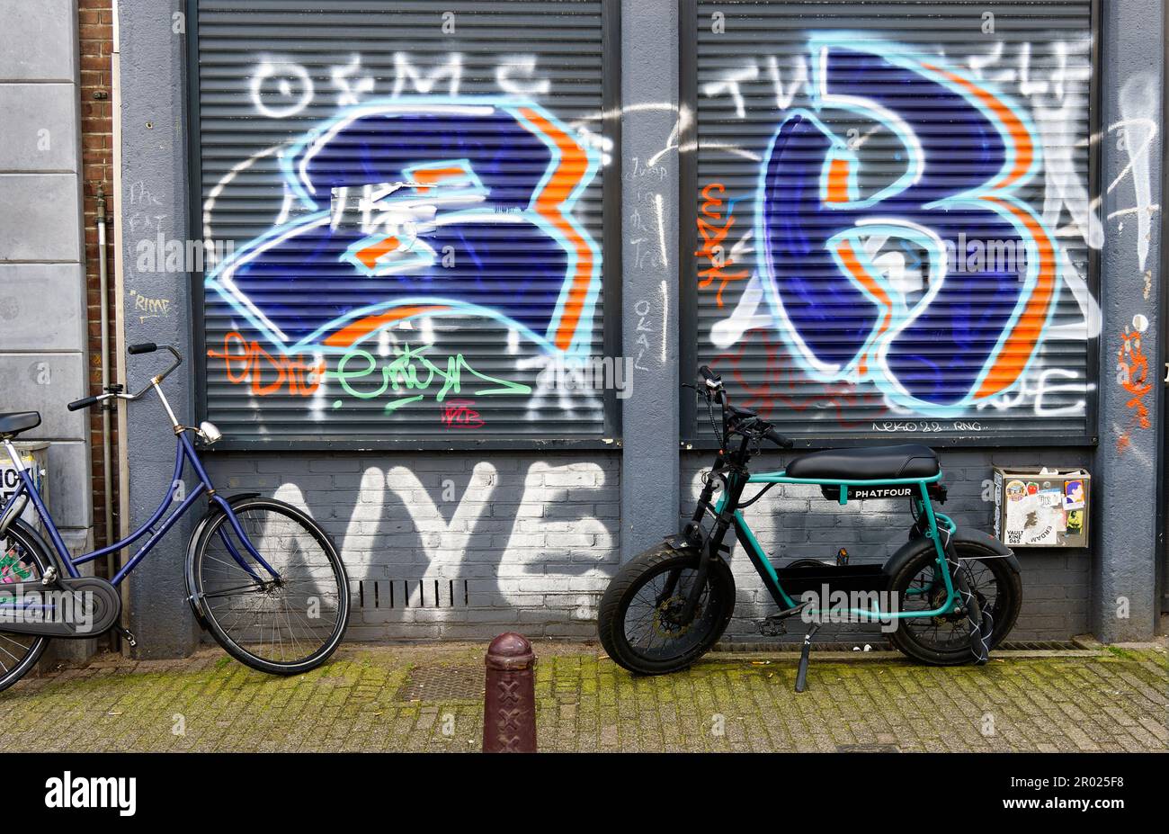 Typical Amsterdam street scene of street art graffiti and parked ...
