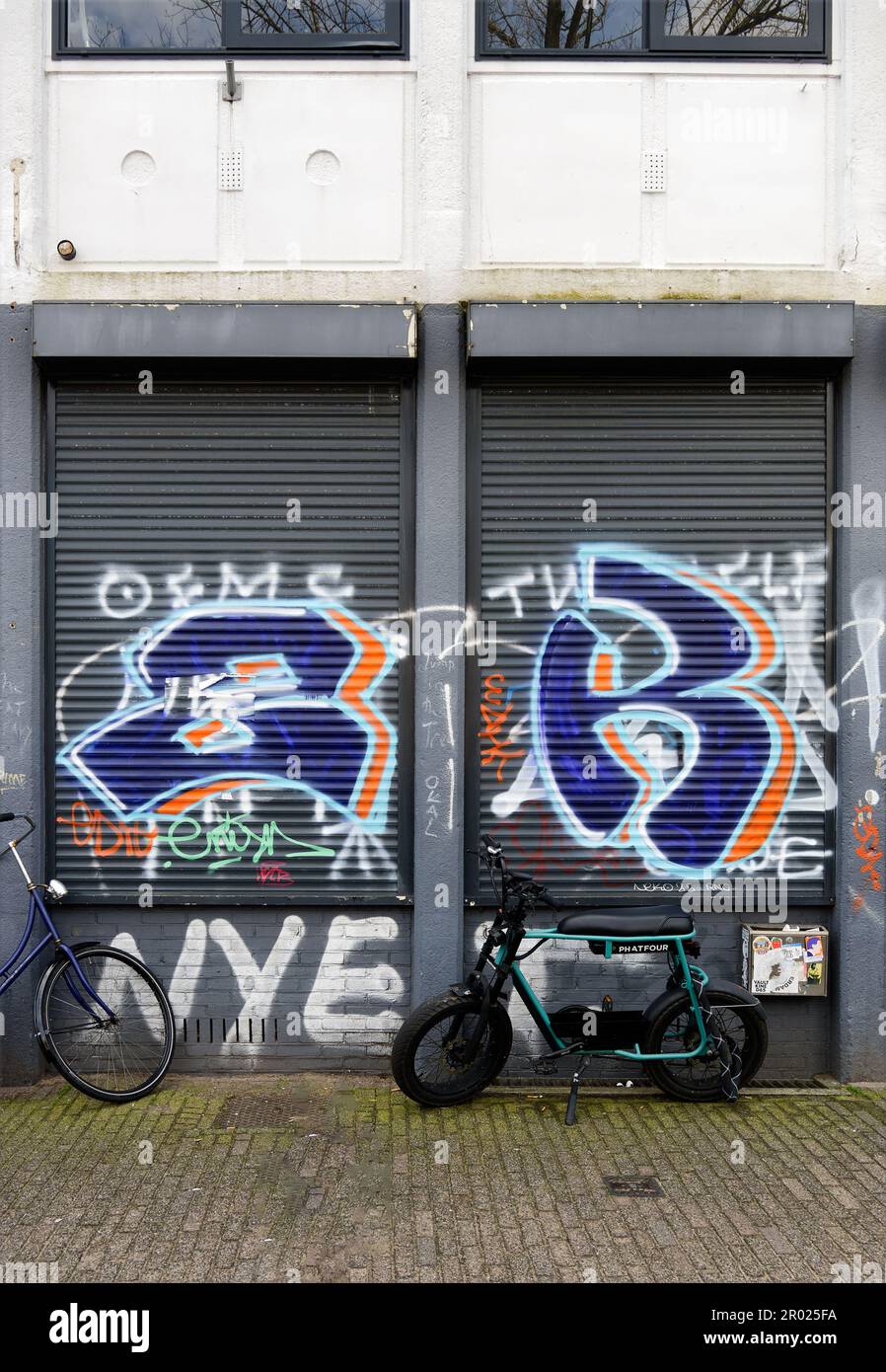 Typical Amsterdam street scene of street art graffiti and parked ...