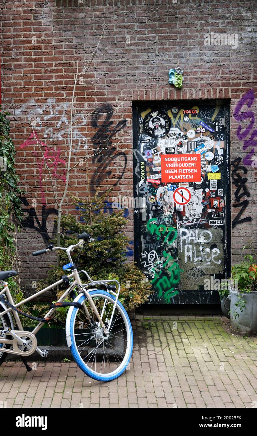 Typical Amsterdam street scene of street art graffiti and parked ...