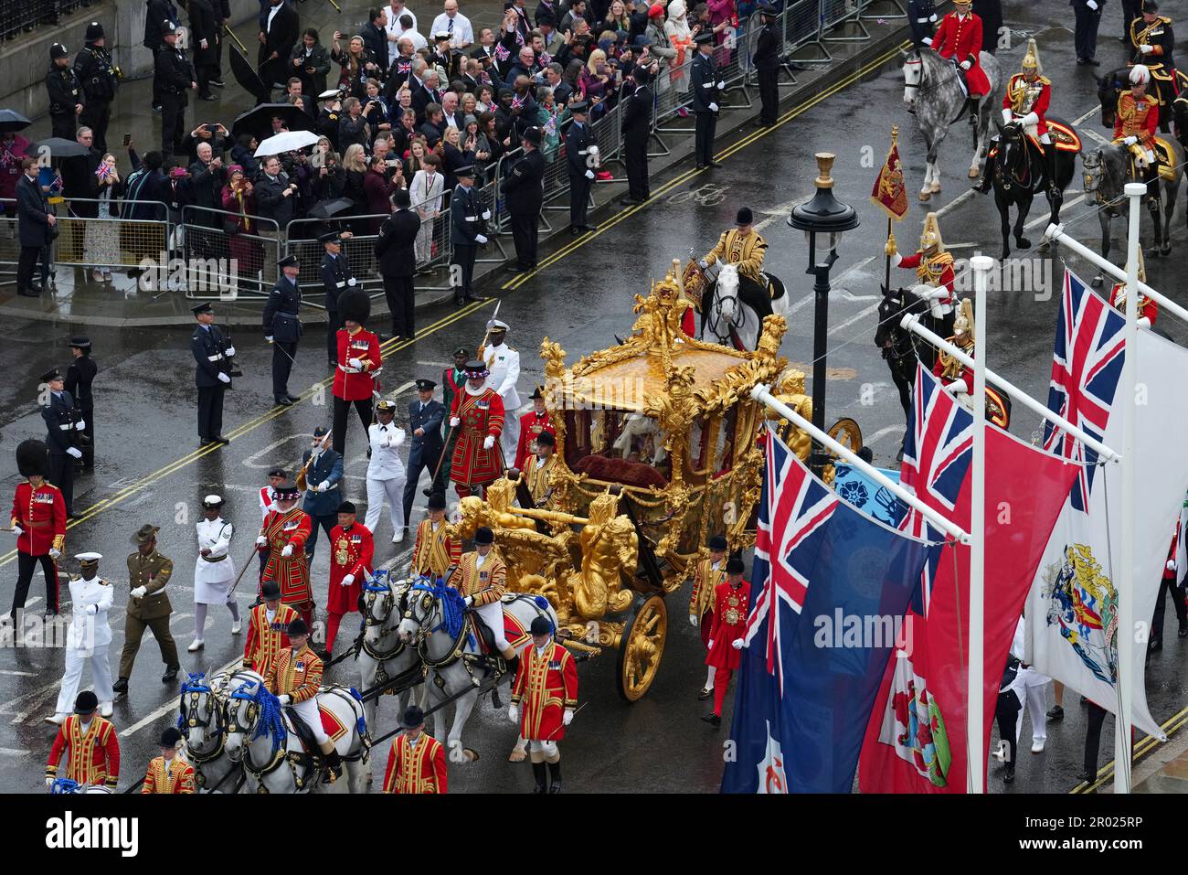 King Charles III and Queen Camilla are carried in the Gold State Coach ...