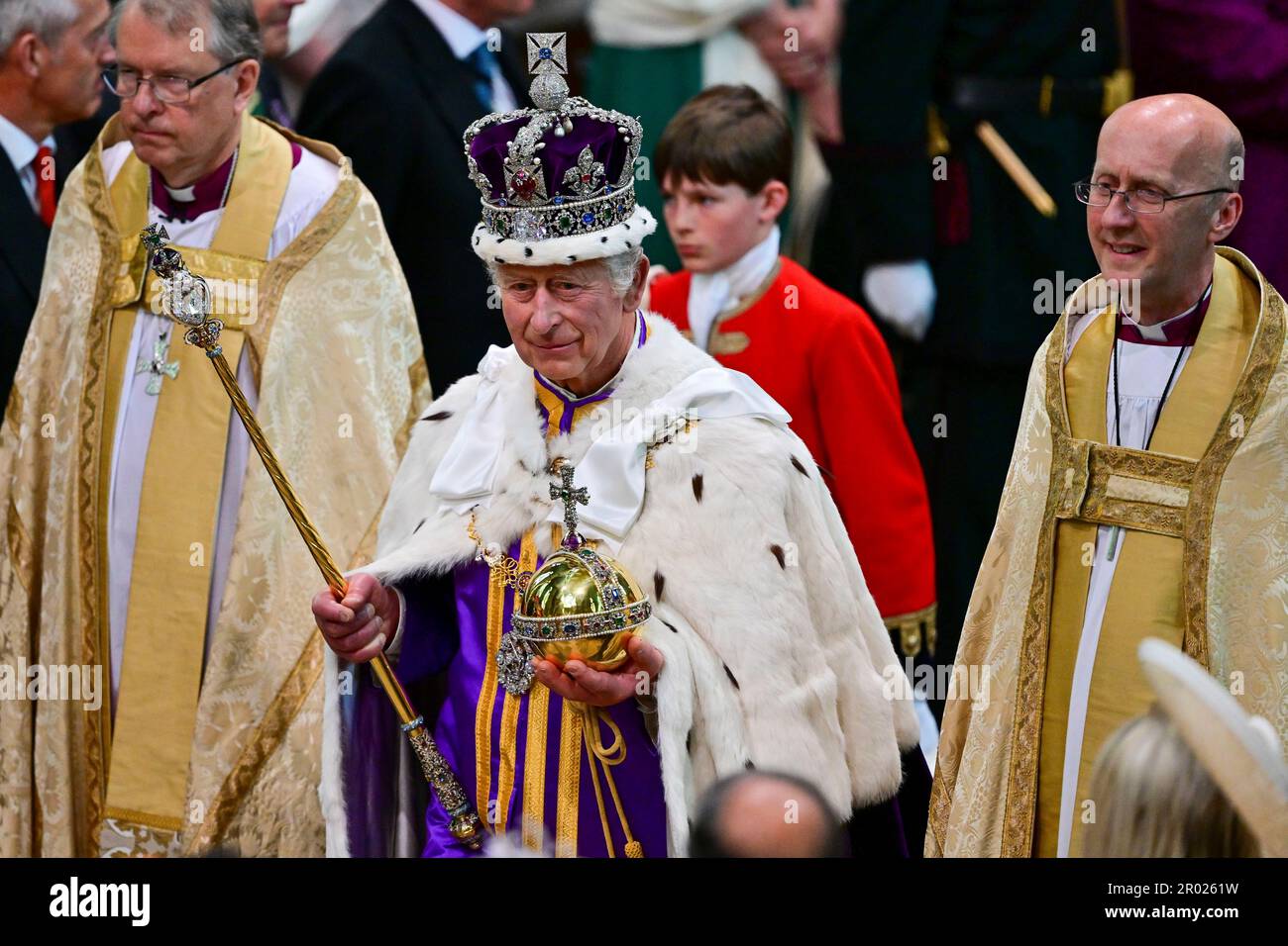 Britain's King Charles III wears the Imperial State Crown and holds the ...