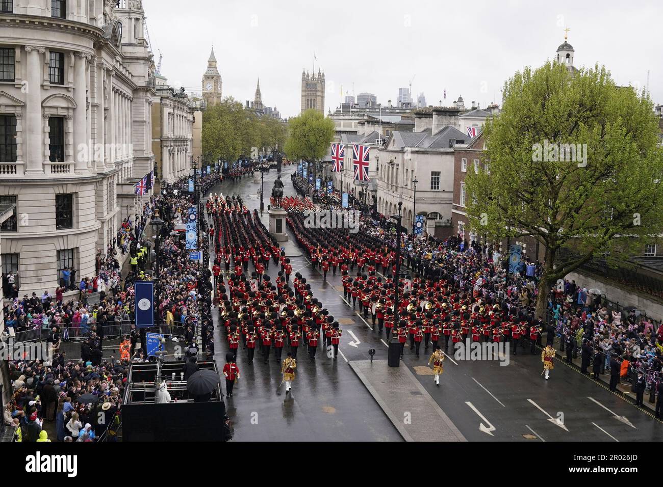 The Coronation Procession passes along Whitehall to Buckingham Palace ...