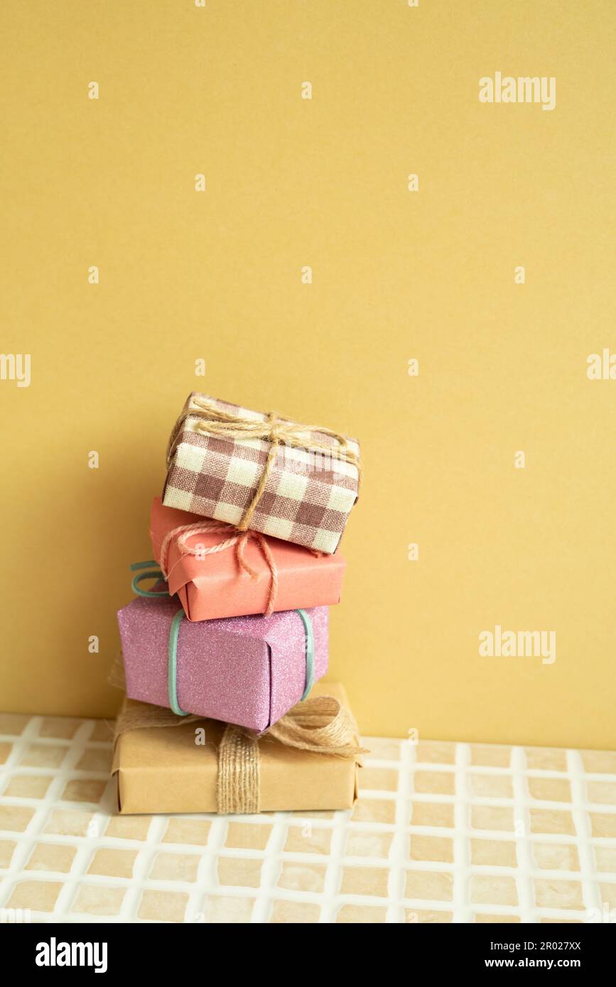 Gift boxes on table. yellow background. anniversary birthday party ...