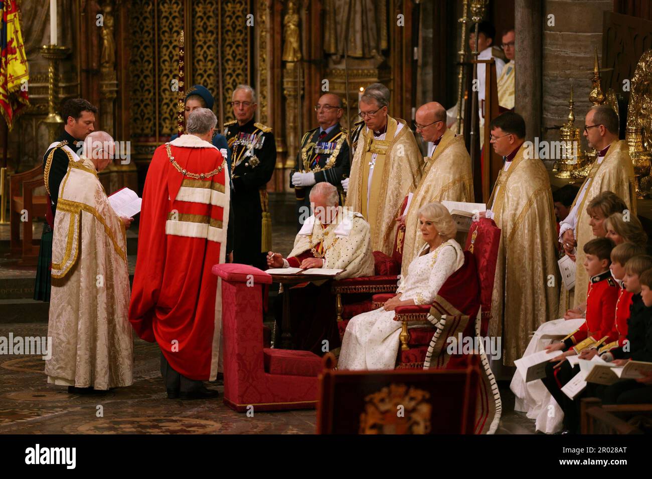 King Charles III and Queen Camilla sit during their coronation at ...