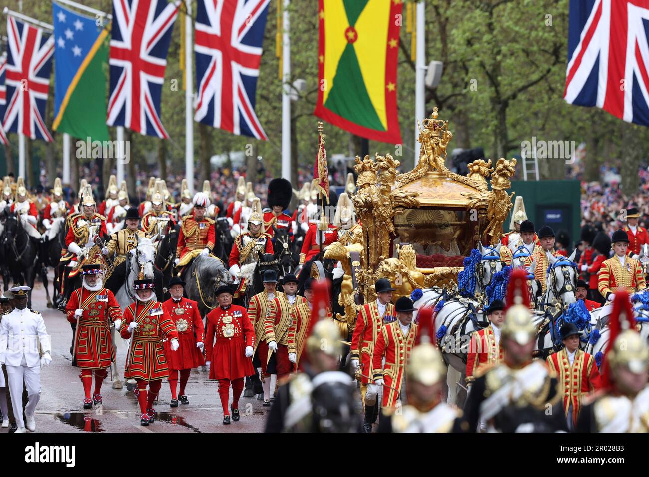 Britain's Queen Camilla and Britain's King Charles III travel in the Gold State Coach, back to ...
