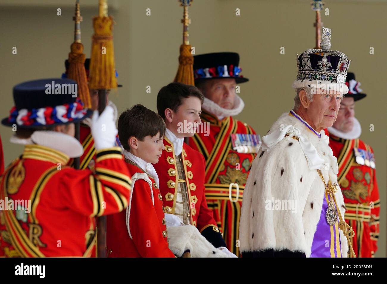 Britain's King Charles III, right, arrives to receive a royal salute ...
