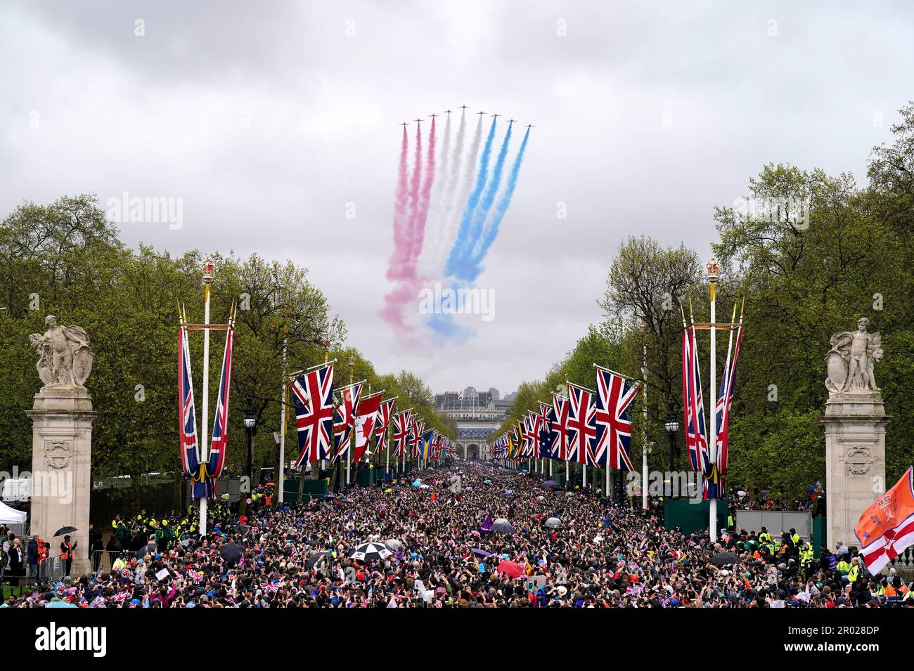 A general view of flypast by aircraft from the Red Arrows over the Mall ...