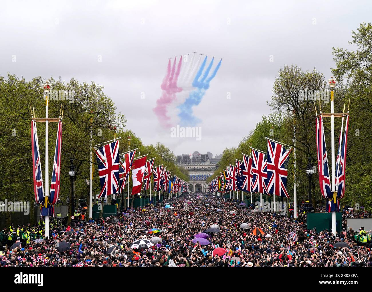 A general view of flypast by aircraft from the Red Arrows over the Mall ...