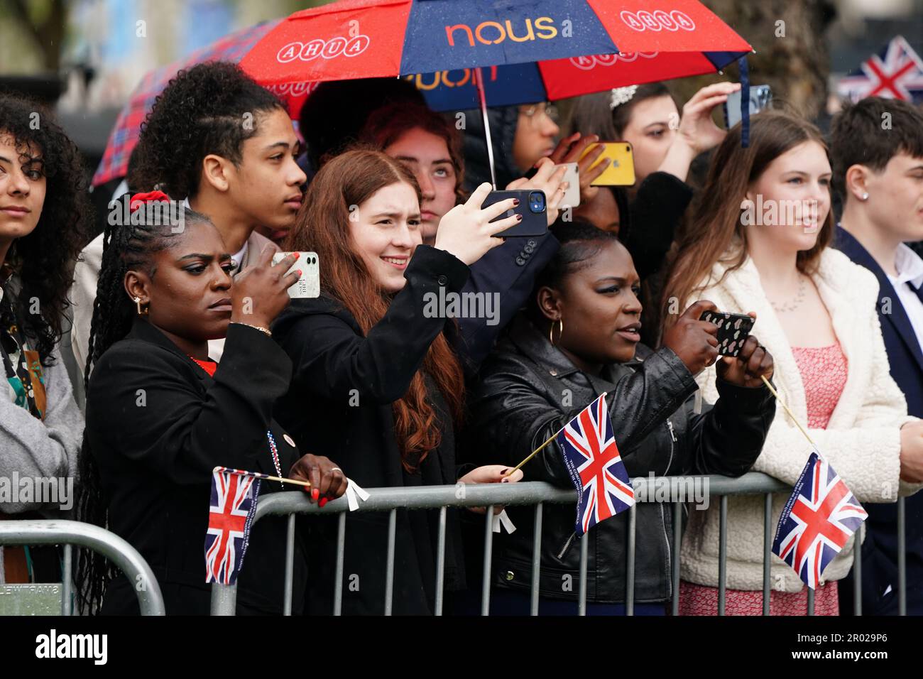 The crowd take pictures on their mobile phones as the Coronation ...