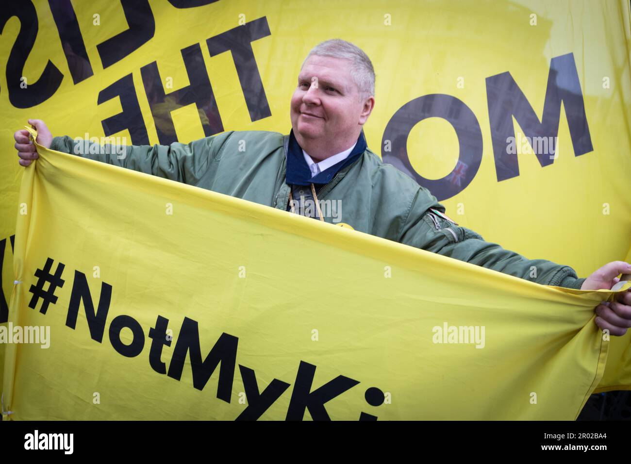 A protester with a banner awaits the start of the coronation. Anti ...