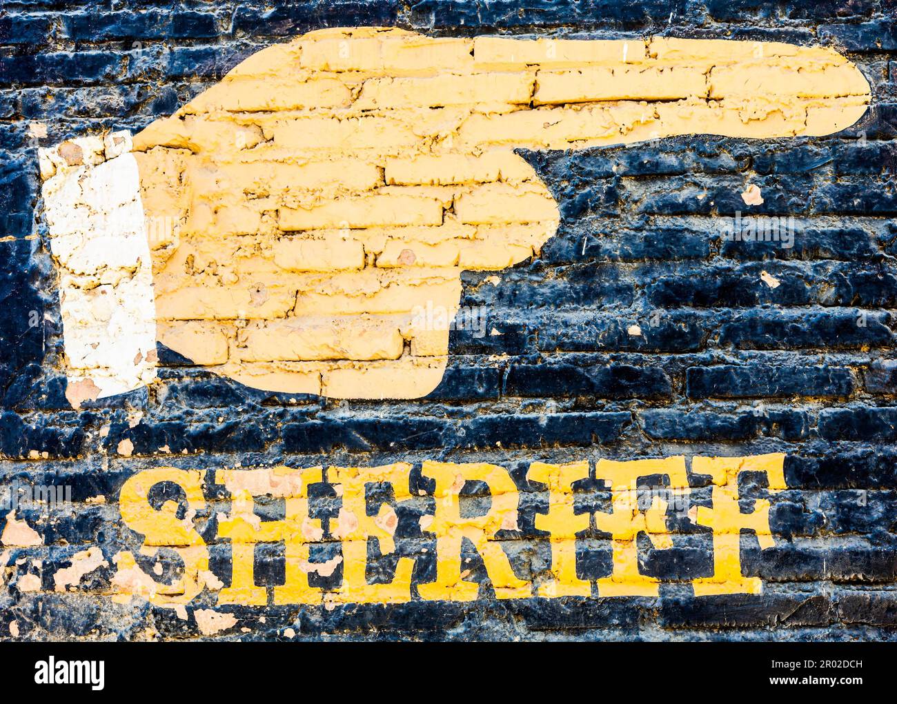 Sheriff graffiti on an old brick wall. Concept for security Stock Photo ...