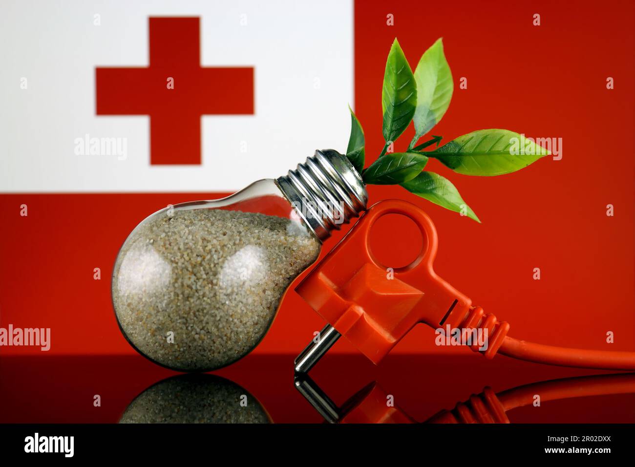 Plug, plant growing inside the light bulb and Tonga Flag. Green eco ...
