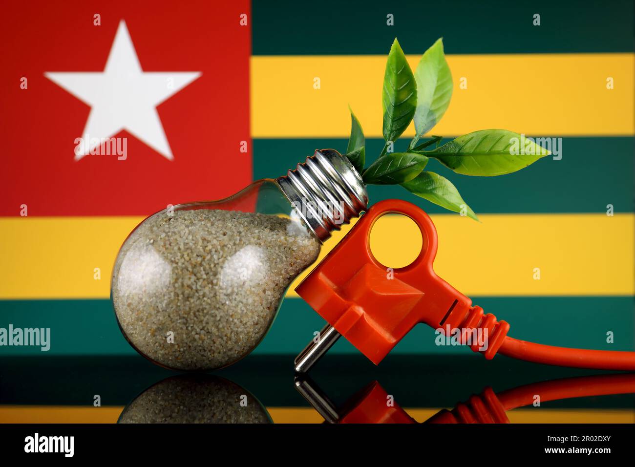 Plug, plant growing inside the light bulb and Togo Flag. Green eco ...