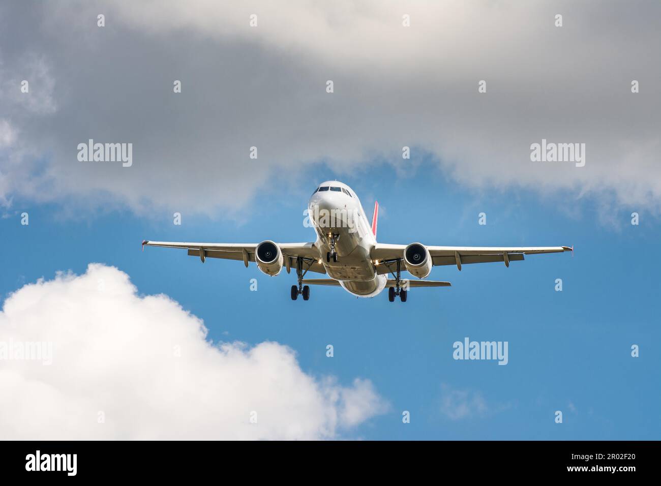 Passenger aircraft flying in the sky Stock Photo - Alamy