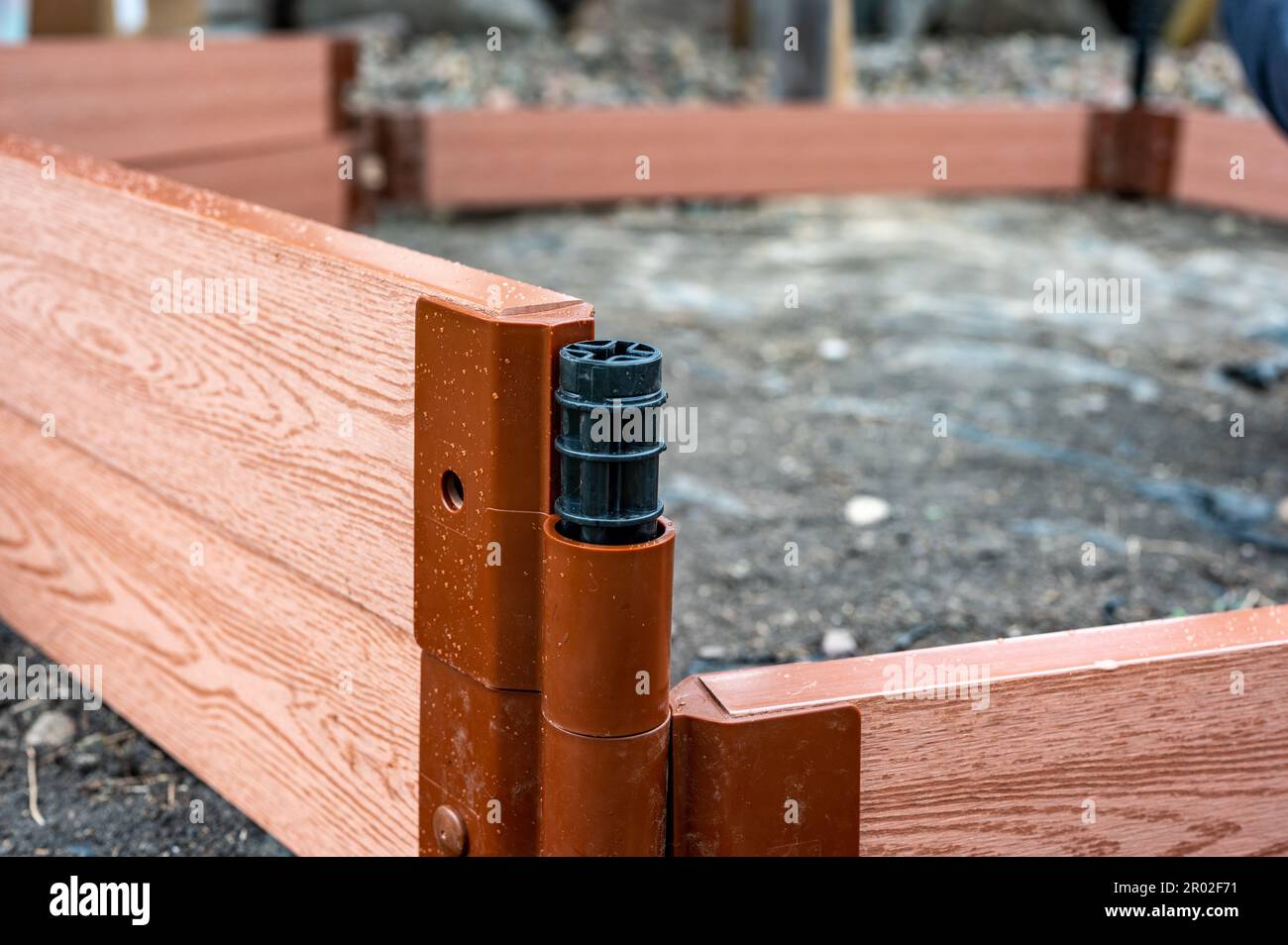Assembling a raised bed garden panel with plastic connectors Stock ...