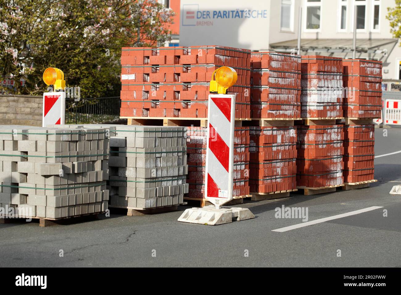 Stacked red building blocks with barrier beacons on a construction site ...
