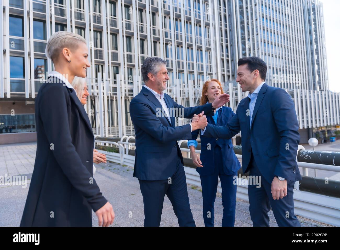 Professional Executives Welcoming Each Other in Urban Business District ...