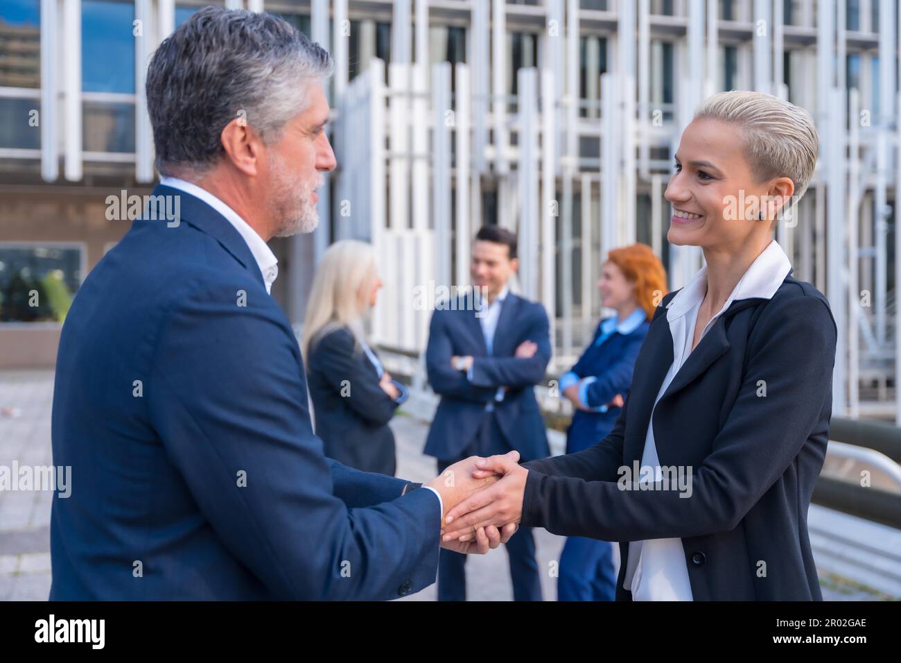 Successful Executives Congratulating Each Other in a Commercial Hub ...