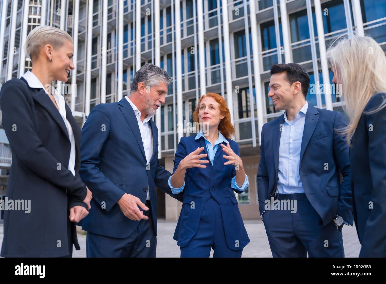 Business Executives Engaged in Conversation and Laughter in Corporate ...