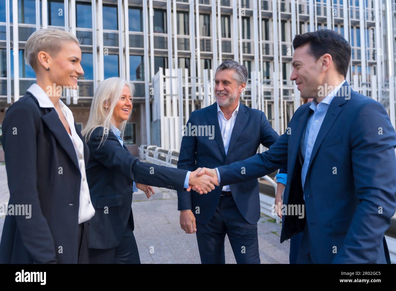 Executives Exchanging Greetings in Commercial Center Stock Photo - Alamy