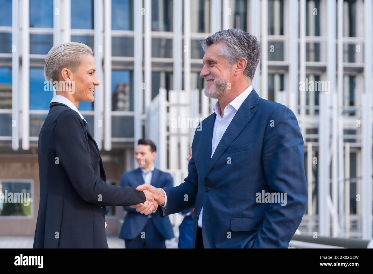 Businessmen in Suits Greeting Each Other in a Cityscape Stock Photo - Alamy