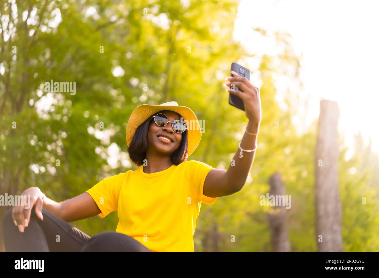 Golden Hour: African American Female Tourist Taking a Selfie at Sunset ...